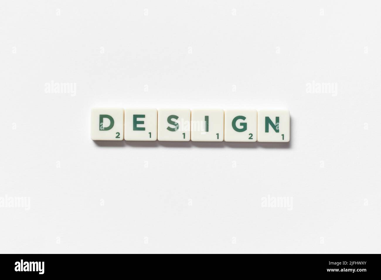 Design formed of scrabble tiles on white background Stock Photo - Alamy