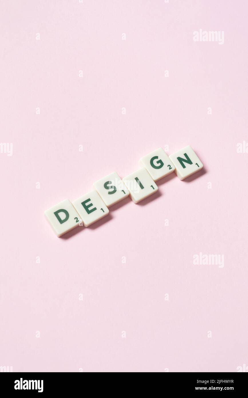 Design formed of scrabble blocks on pink background Stock Photo - Alamy