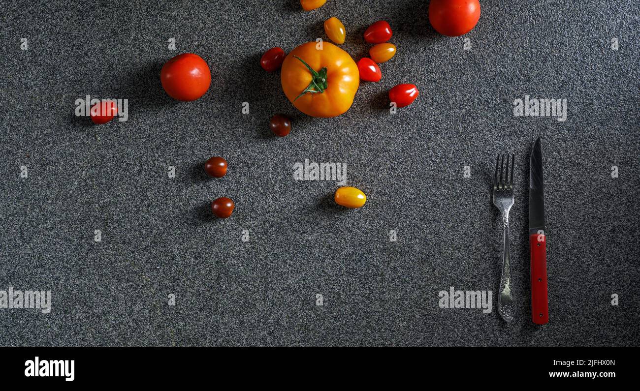 Food border with red and orange tomatoes. Vegetables, red knife and ...
