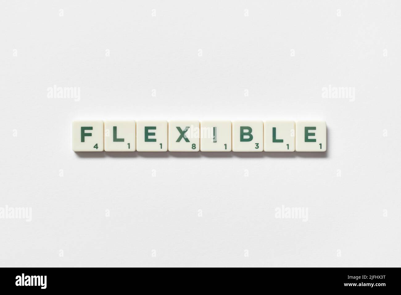 Flexible formed of scrabble tiles on white background Stock Photo - Alamy