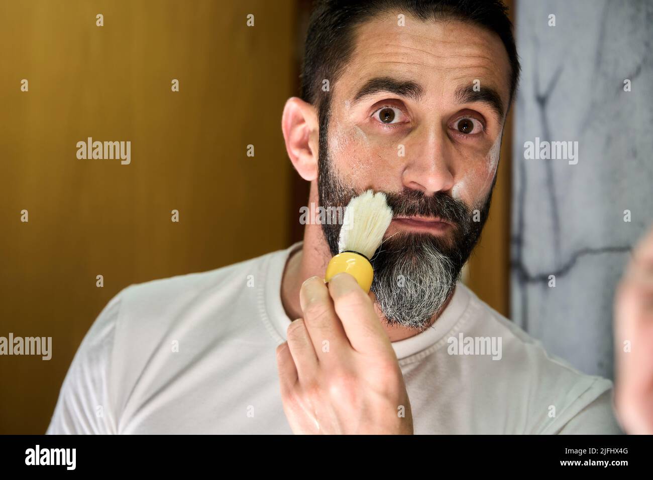 Young man soaping his face to shave his beard. High quality photo Stock ...