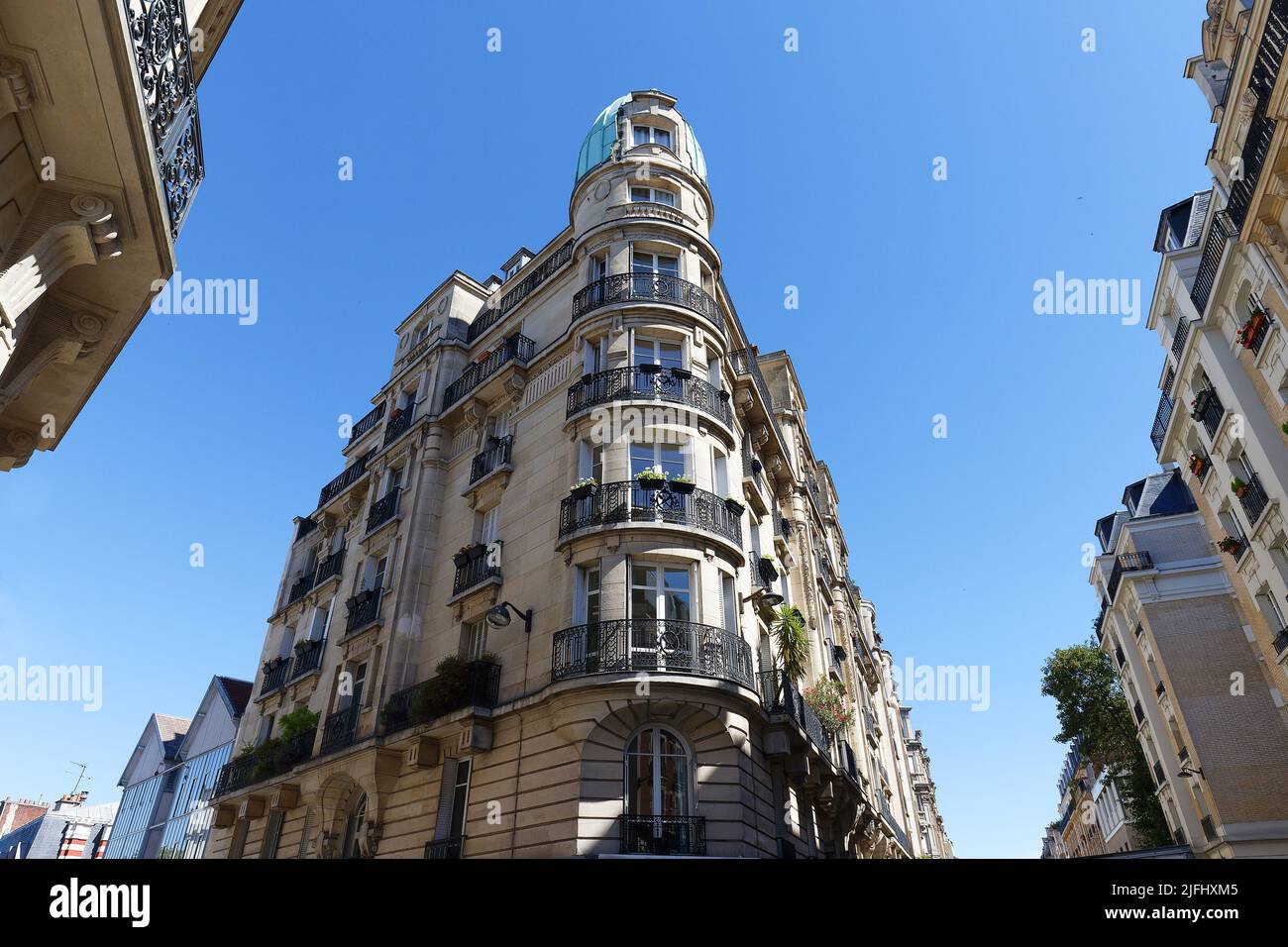 The facades of traditional French houses with typical balconies and ...