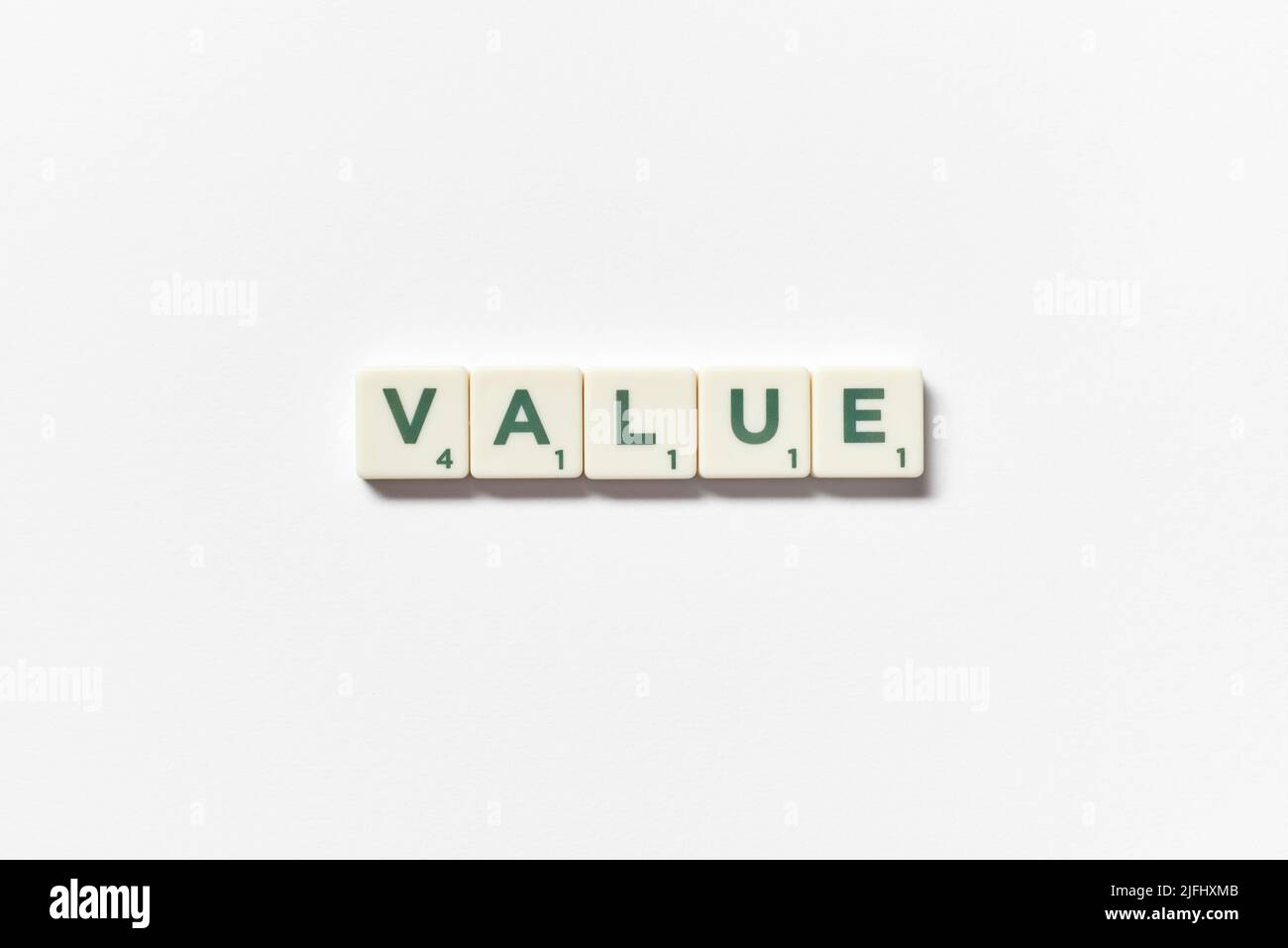 Value formed of scrabble tiles on white background Stock Photo - Alamy