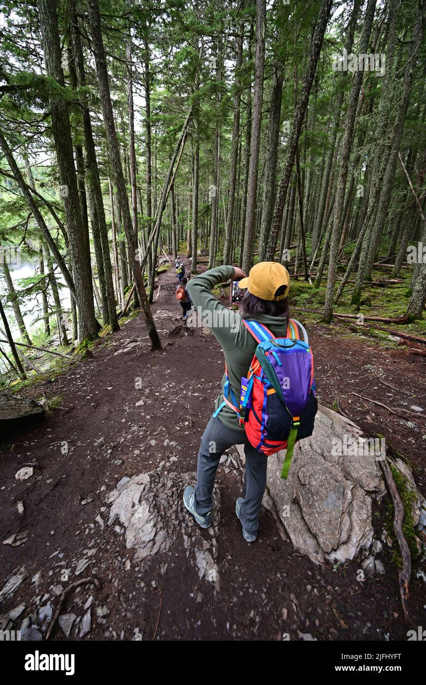 Young woman pauses to take a picture on Johns Lake Loop by McDonald ...