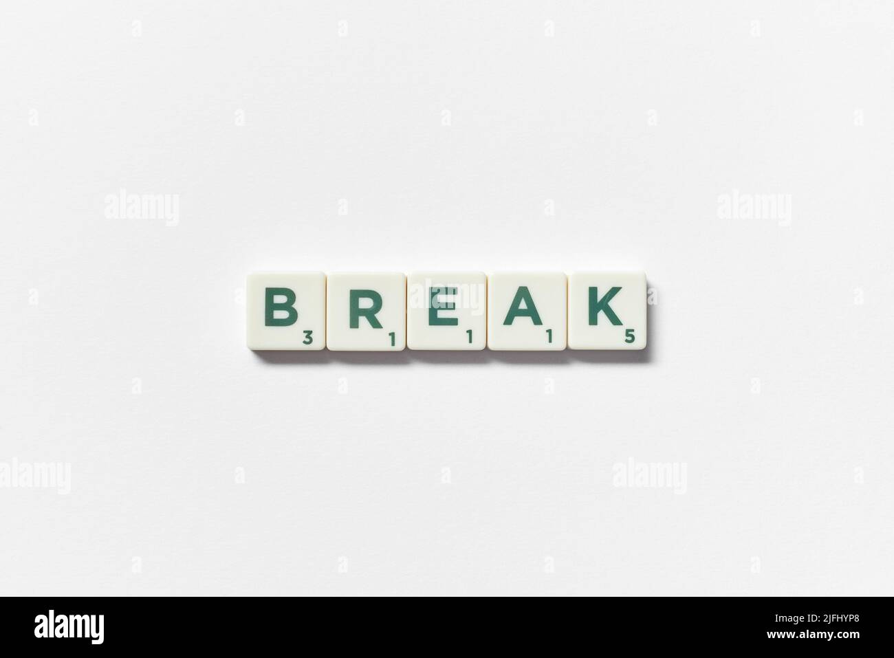 Break formed of scrabble blocks on white background Stock Photo - Alamy