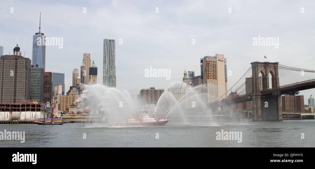 Fireboat spraying water in the east river in New York Stock Photo - Alamy