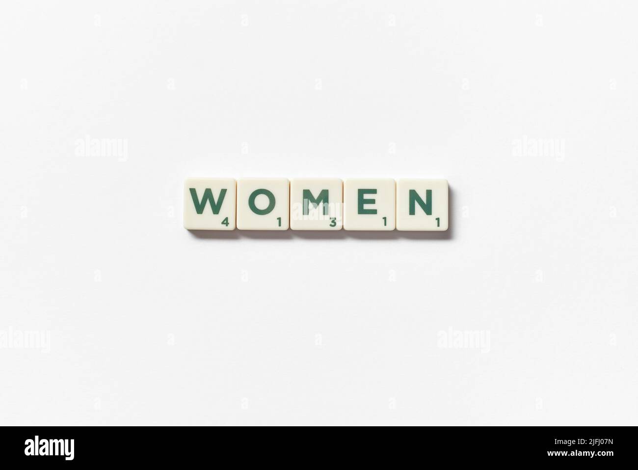 Women formed of scrabble blocks on white background Stock Photo - Alamy