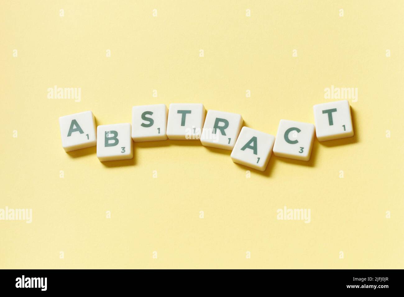 Abstract formed of scrabble blocks on yellow background Stock Photo - Alamy