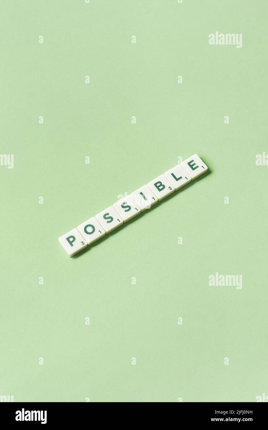 Possible formed of scrabble blocks on green background Stock Photo - Alamy