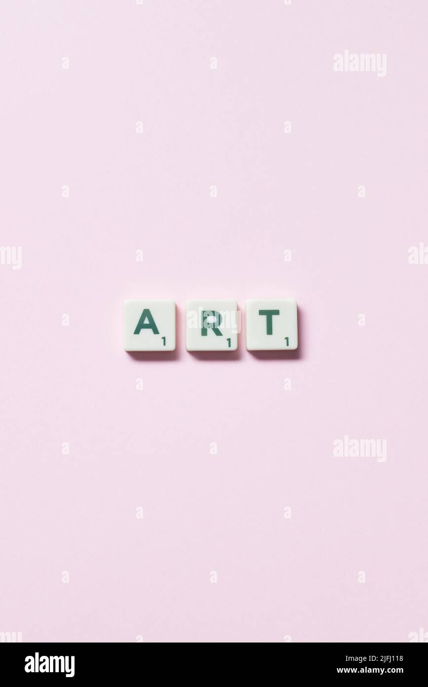 Art formed of scrabble tiles on pink background Stock Photo - Alamy