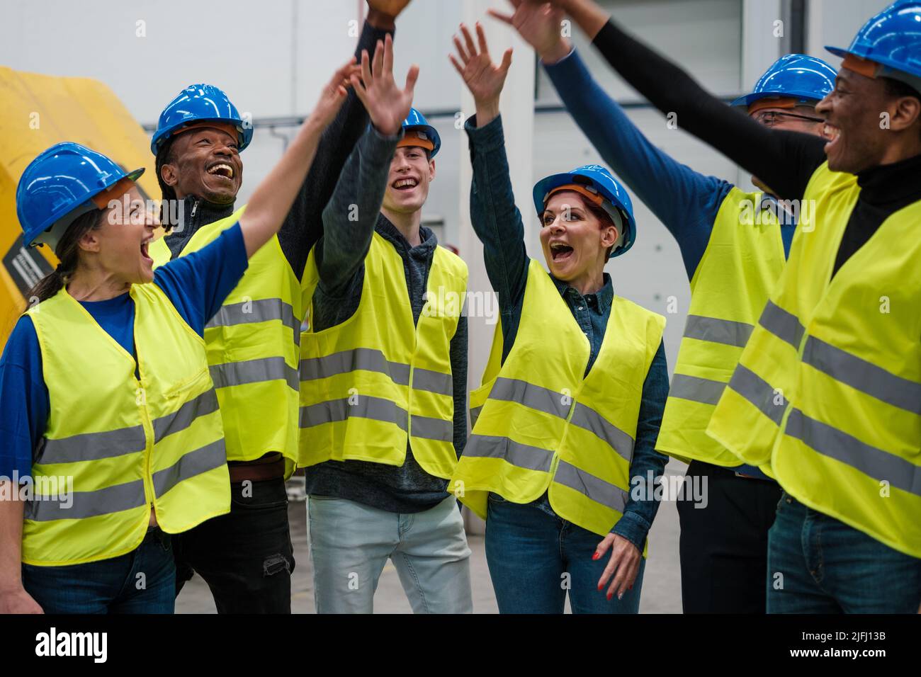 Group of factory workers celebrating good times together Stock Photo ...