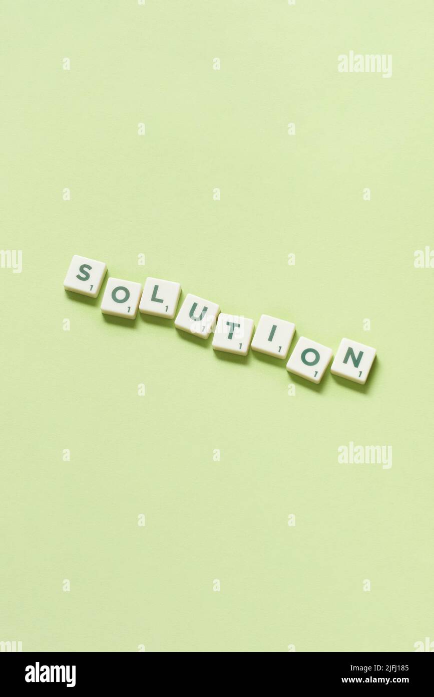 Solution formed of scrabble tiles on green background Stock Photo - Alamy