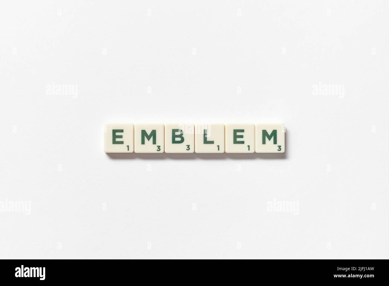 Emblem formed of scrabble tiles on white background Stock Photo - Alamy