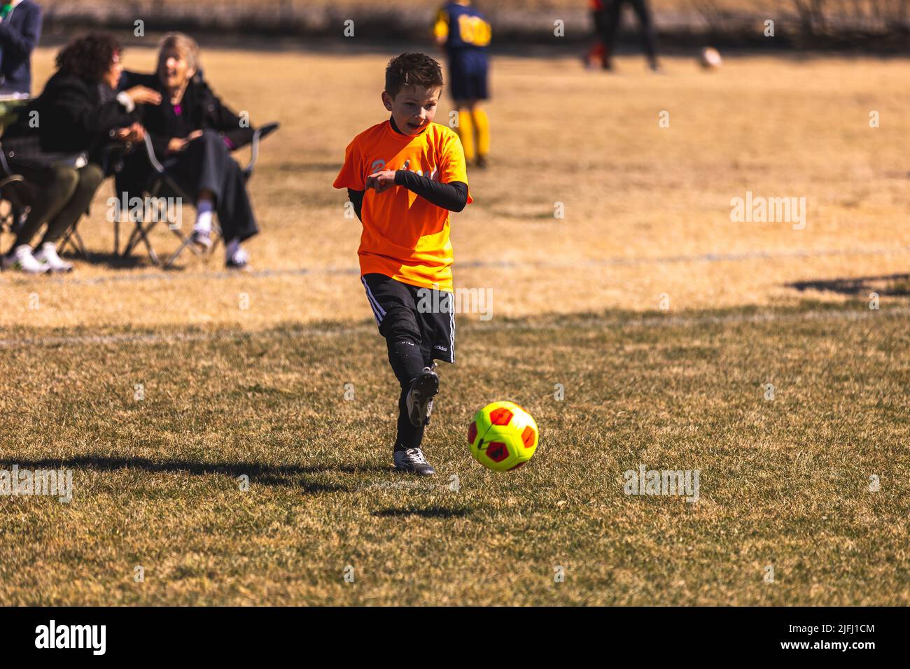 A young soccer player hitting a goal on a field Stock Photo - Alamy