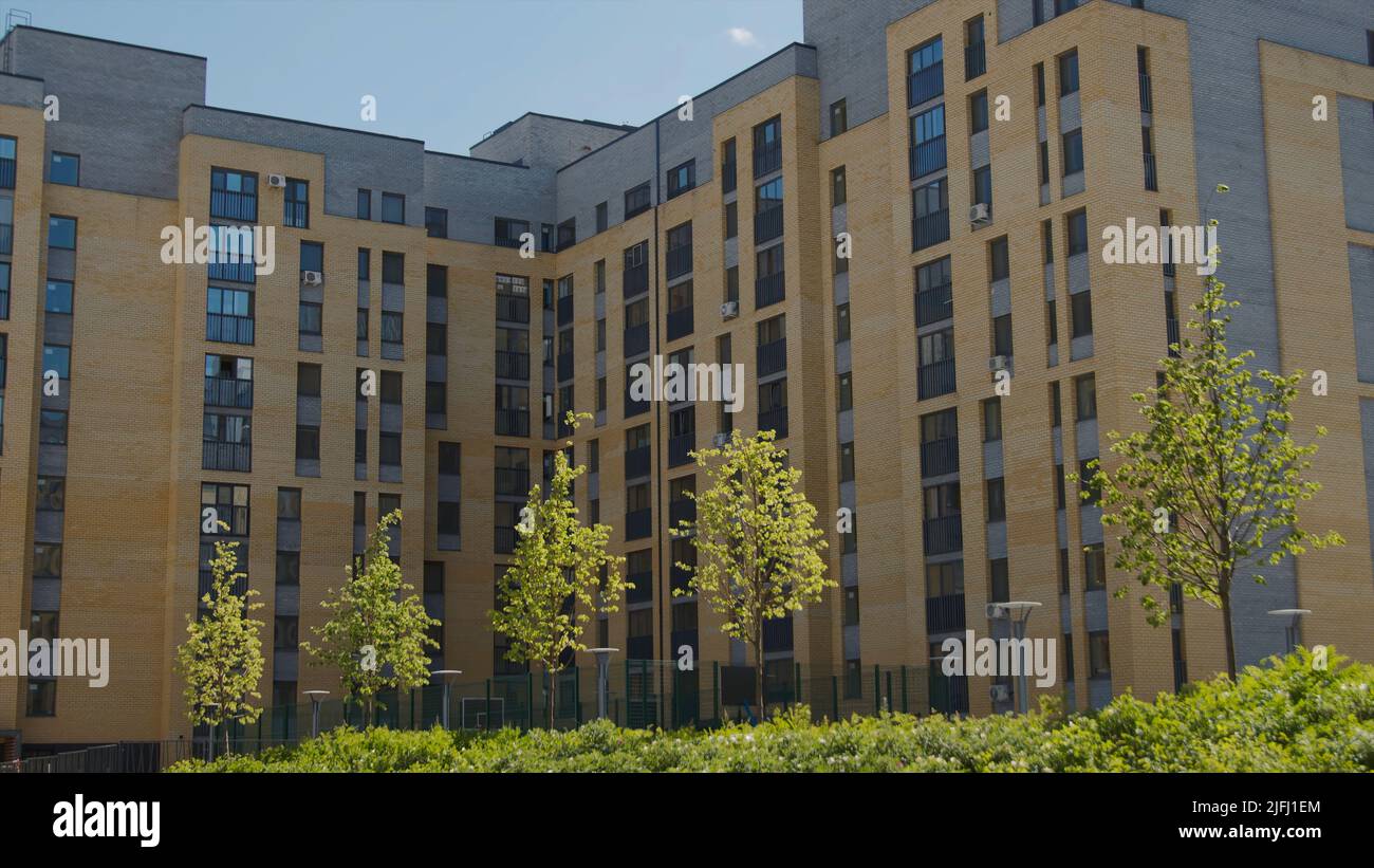 A large high-rise building.Stock footage.A bright yellow brick house ...