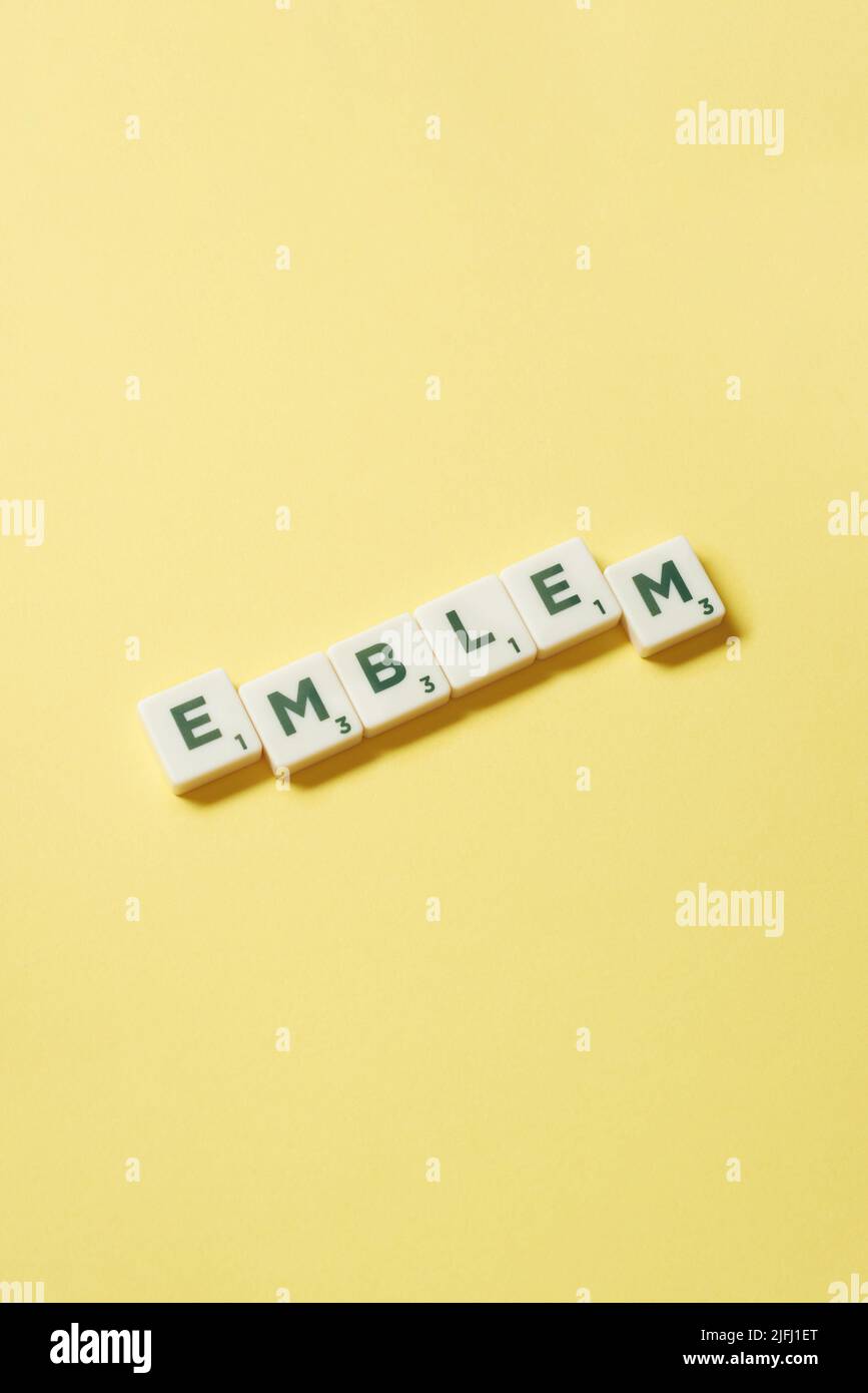 Emblem formed of scrabble tiles on yellow background Stock Photo - Alamy