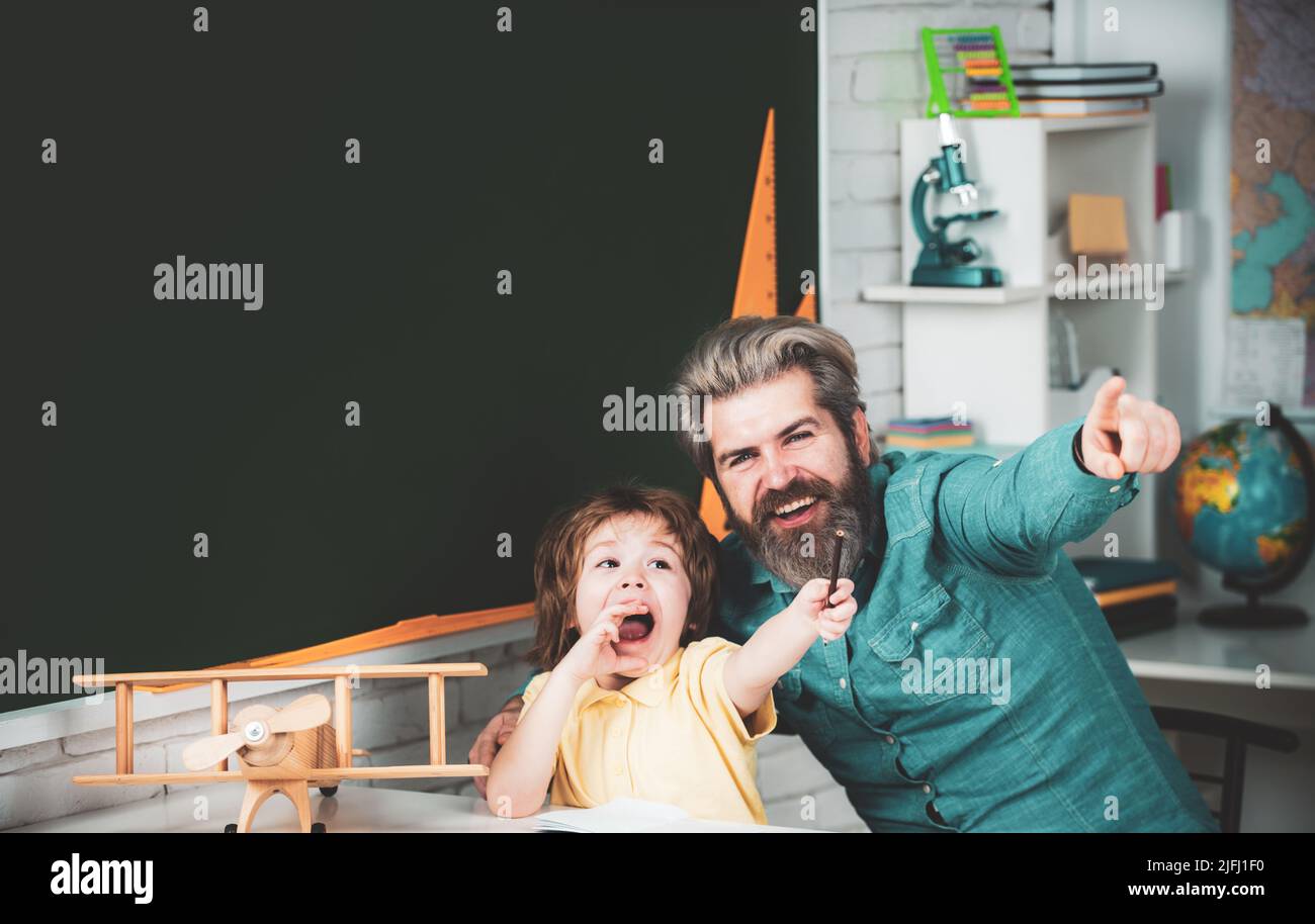 Educational process. Young happy family father and son schooling math ...