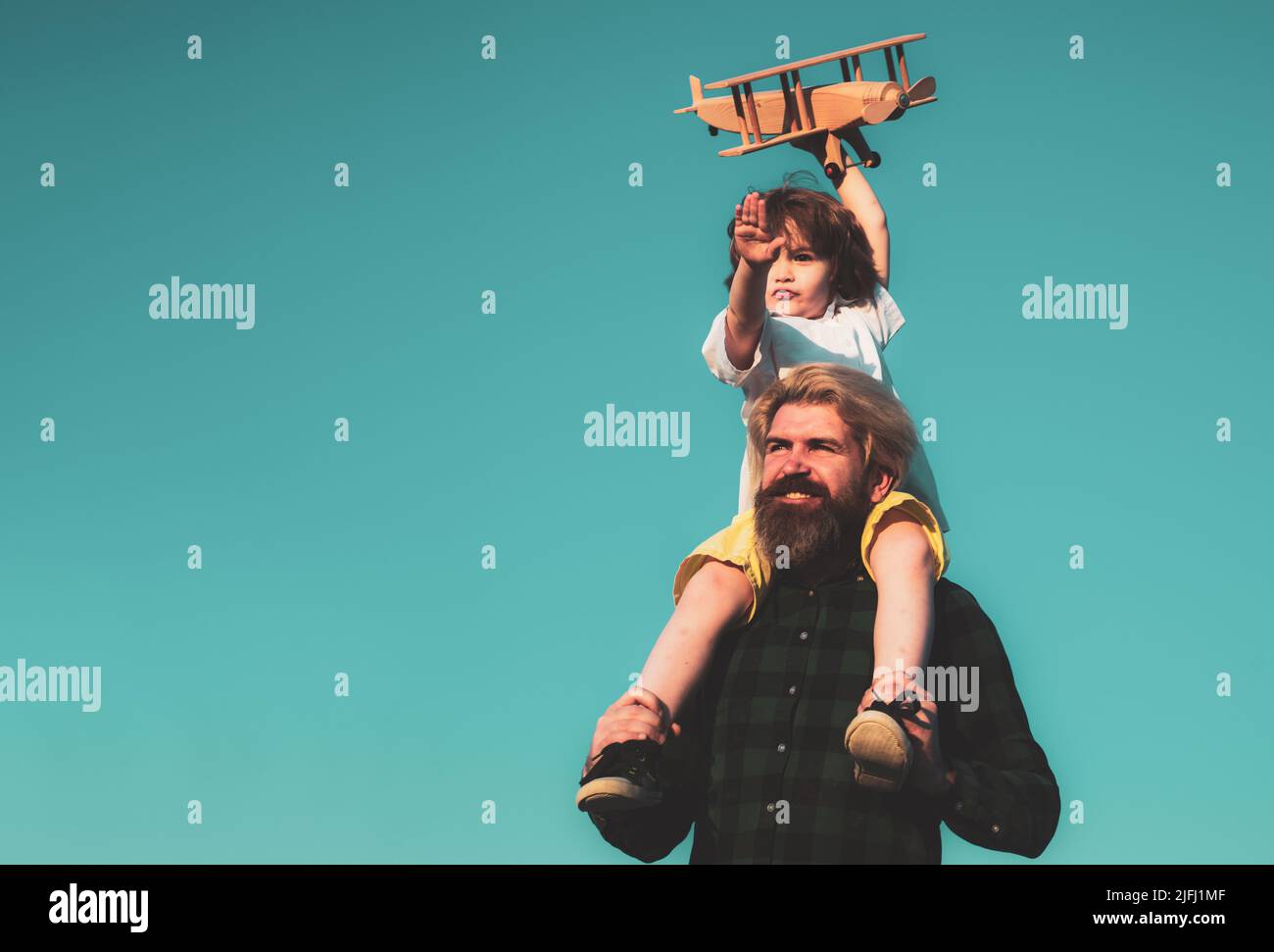 Kid boy pilot. Father and son playing with wooden airplane Stock Photo ...