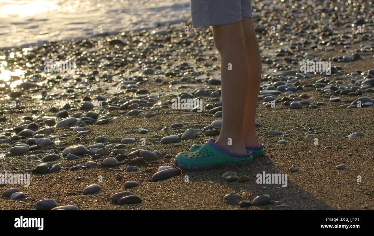 Waves on pebbled beach during sunset. Creative. Vacation Concept, side ...