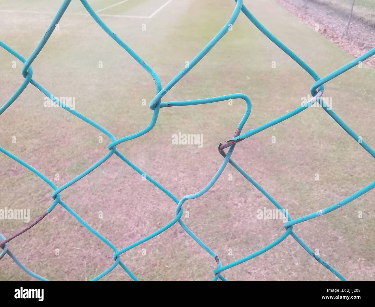 Geometric background image of distorted twisted green chain link ...