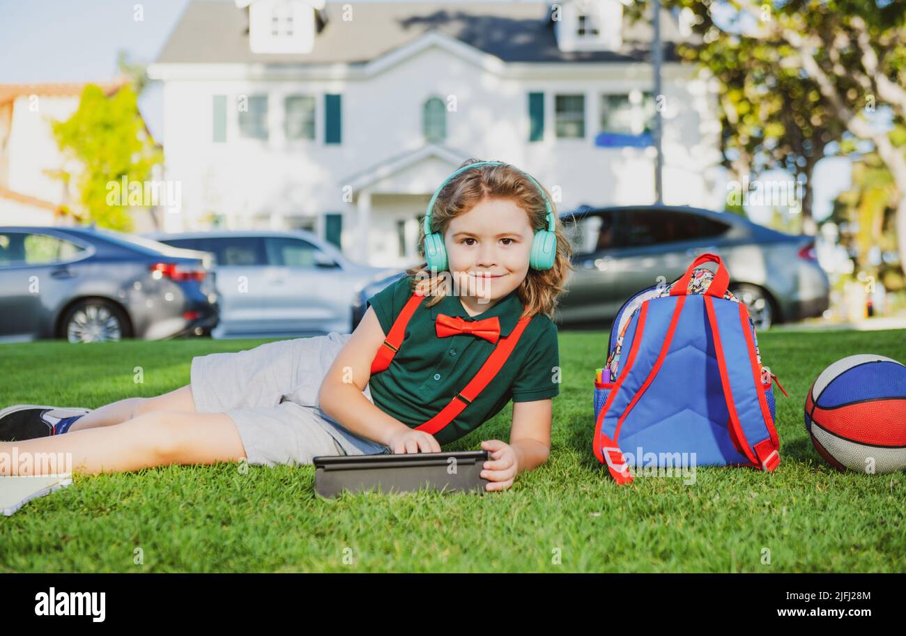 Kid studying online outdoor in park. Study in nature. Online school ...