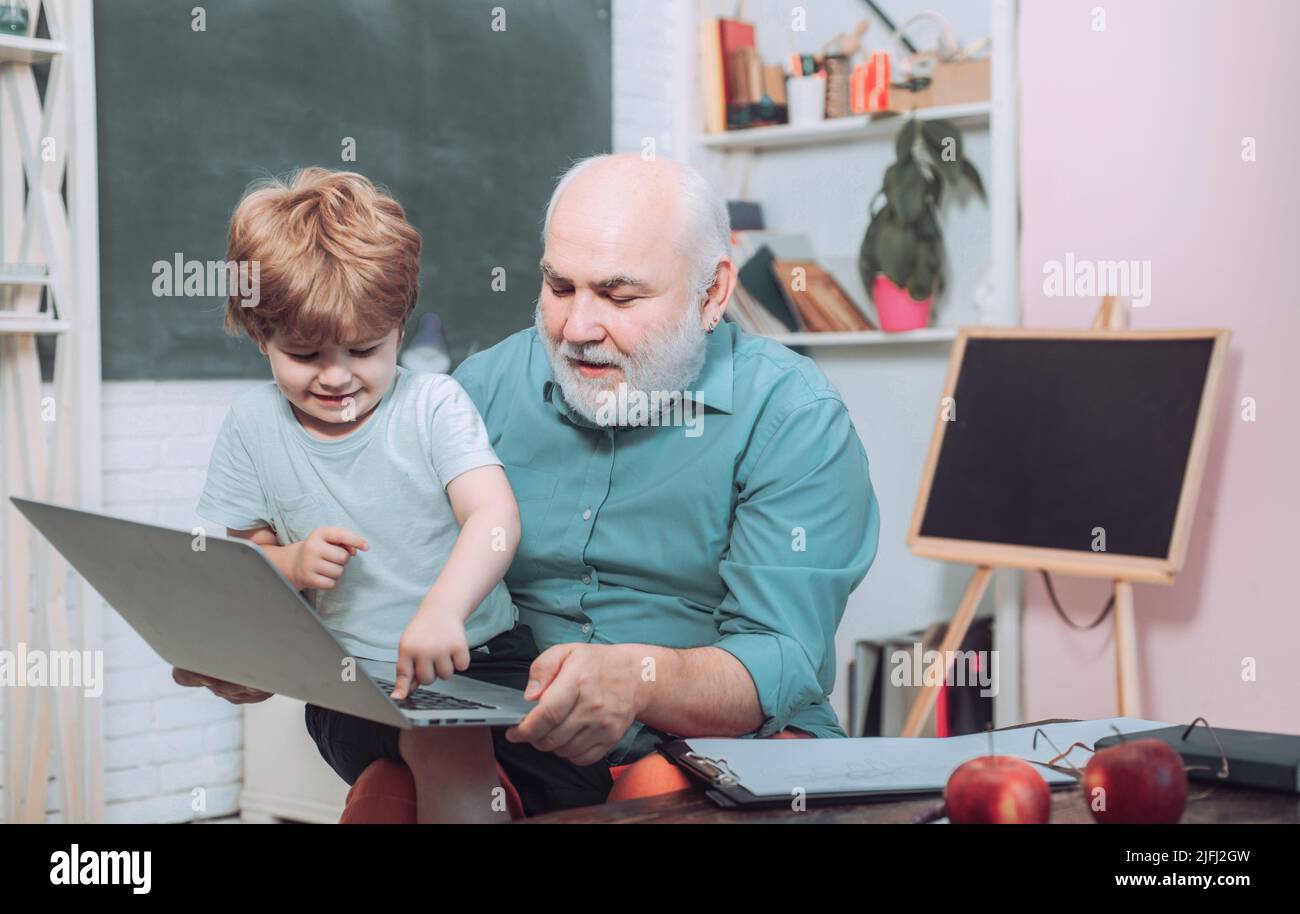 Happy cute clever boy and old tutor with book. Portrait of confident ...