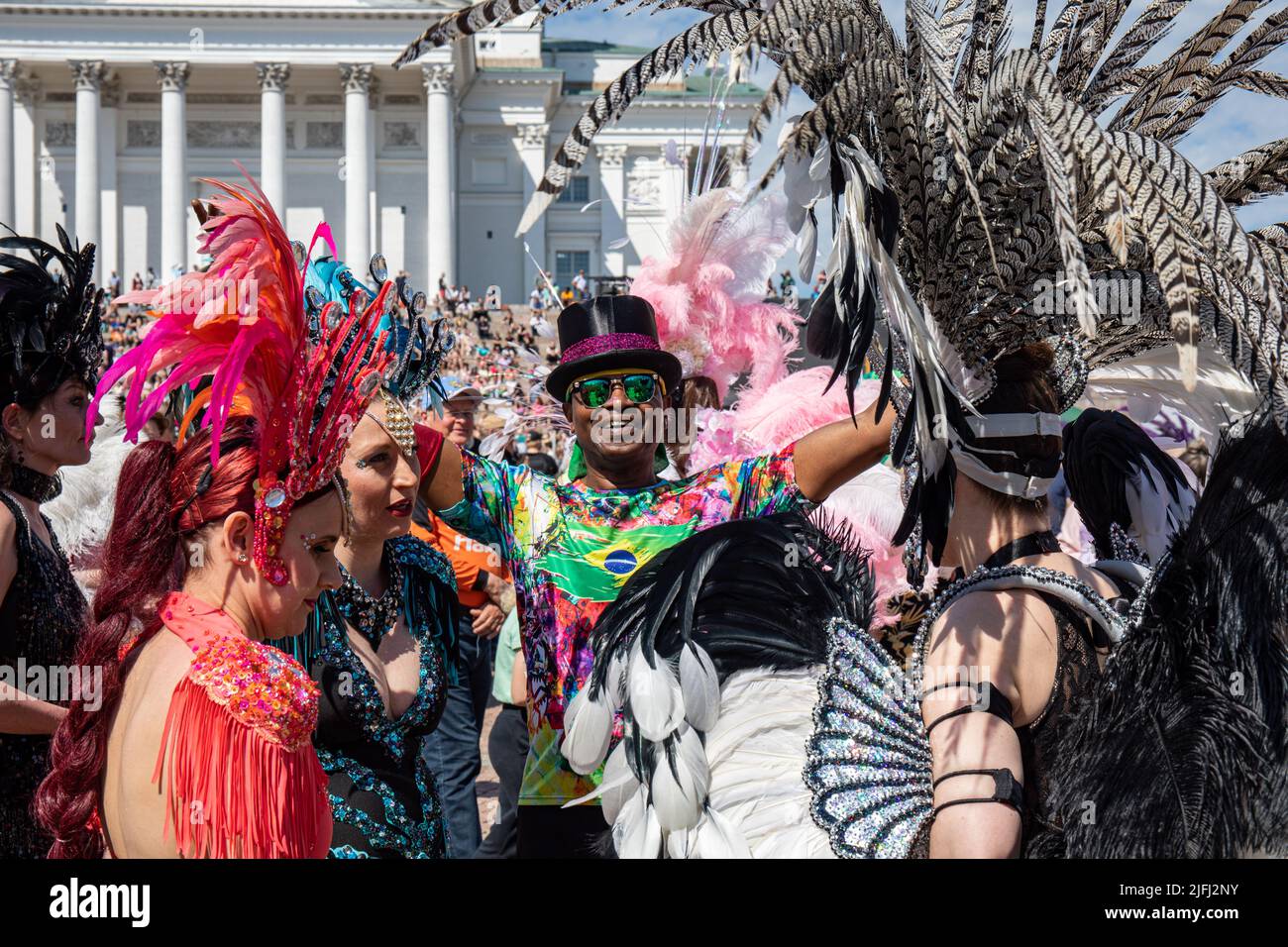 Smiling male samba dance wearing top hat and sunglasses surrounded by ...
