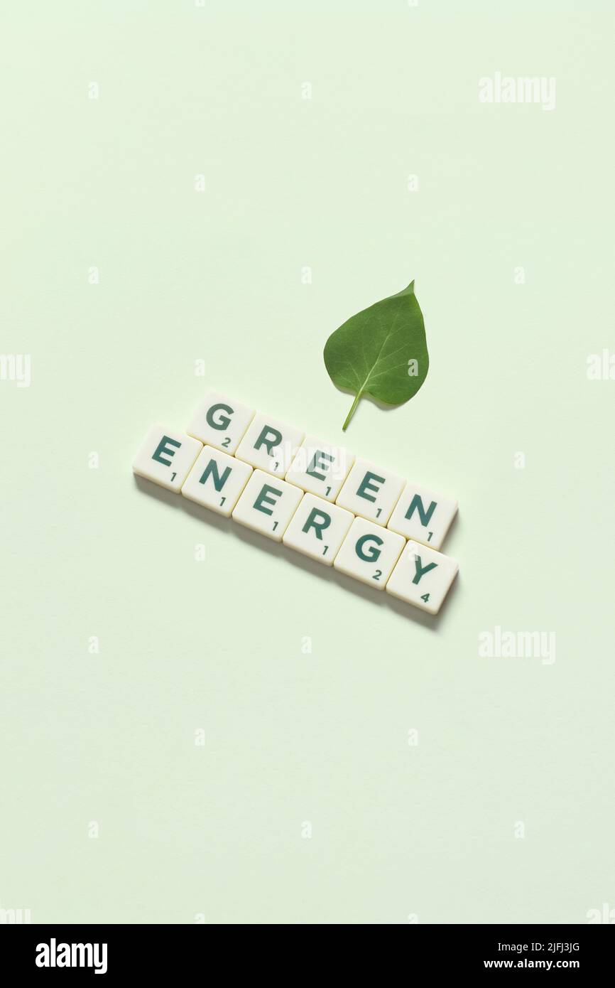 Green energy formed of scrabble tiles with tree leaf Stock Photo - Alamy