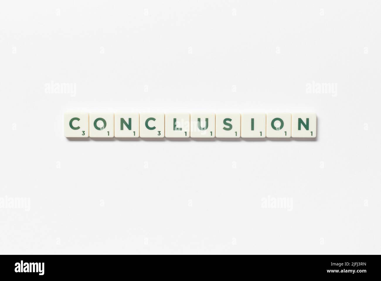 Conclusion formed of scrabble tiles on white background Stock Photo - Alamy