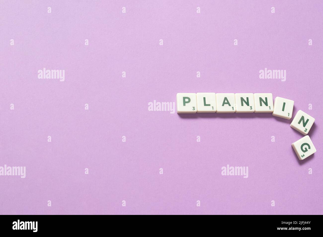 Planning formed of scrabble blocks on lilac background Stock Photo - Alamy