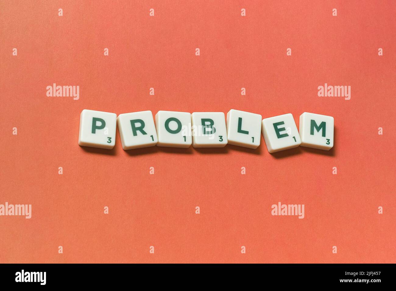 Problem formed of scrabble blocks on red background Stock Photo - Alamy