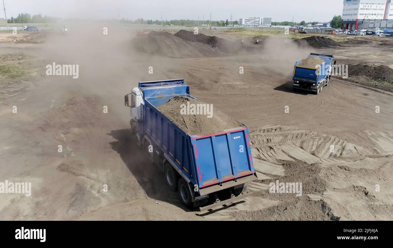 Aerial view of excavator scoop clay soil to a dump truck. Scene ...