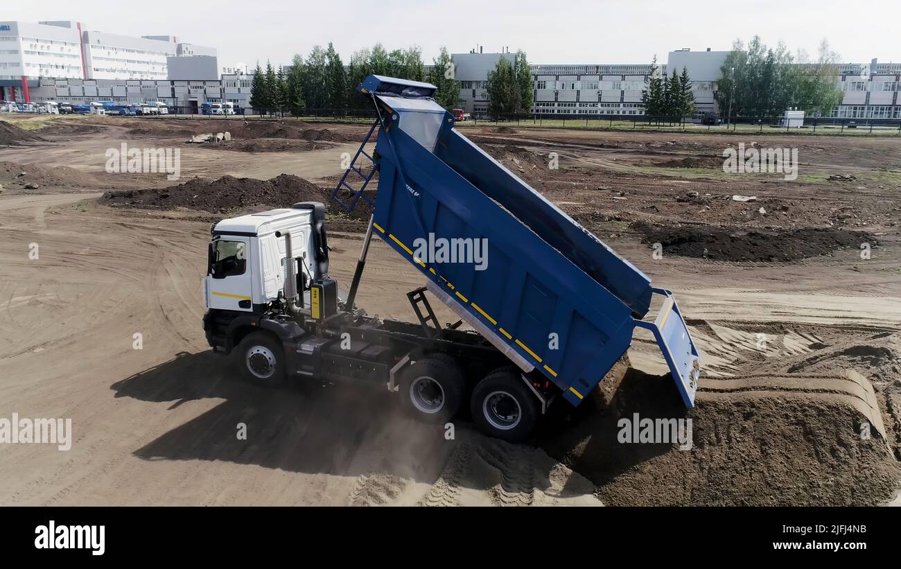 Aerial view of excavator scoop clay soil to a dump truck. Scene ...