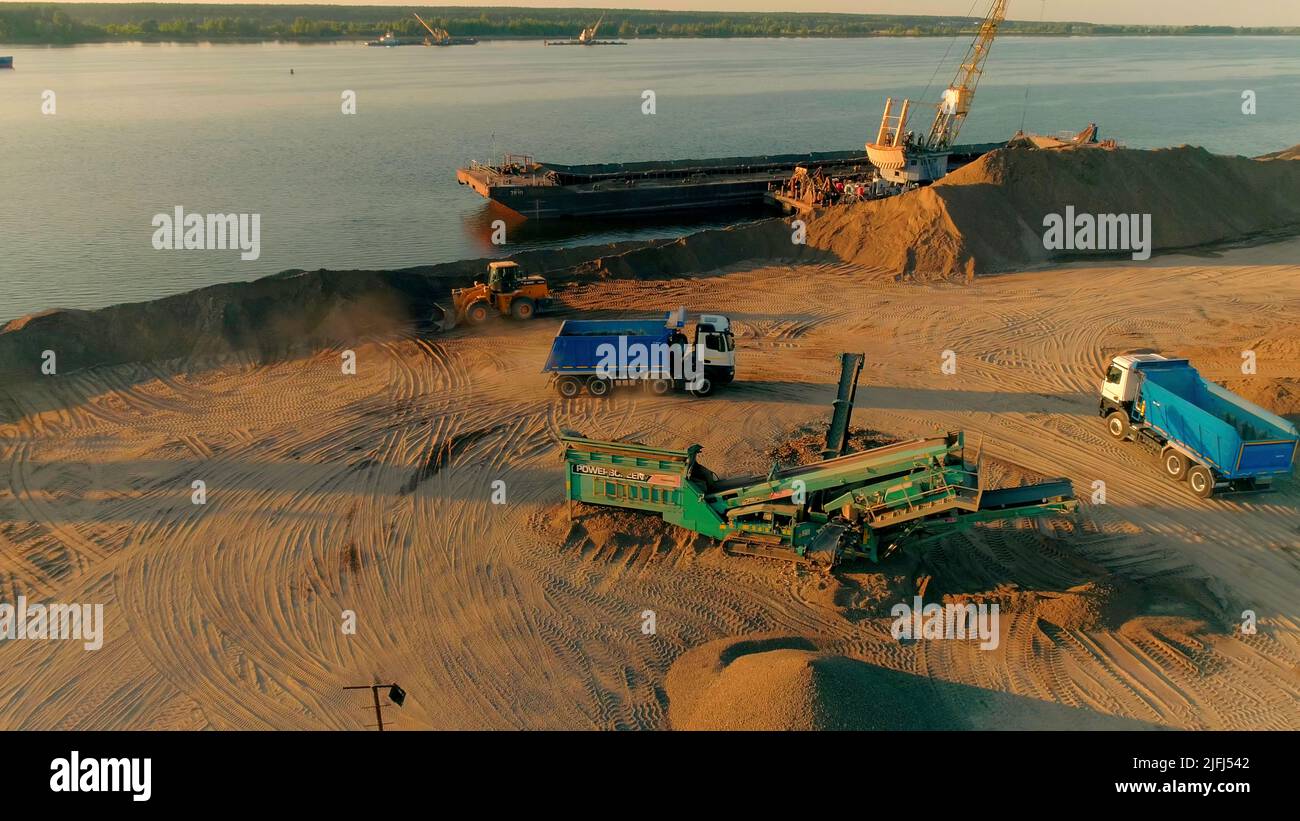 Excavator , trucks and cranes working at the construction site. Scene ...