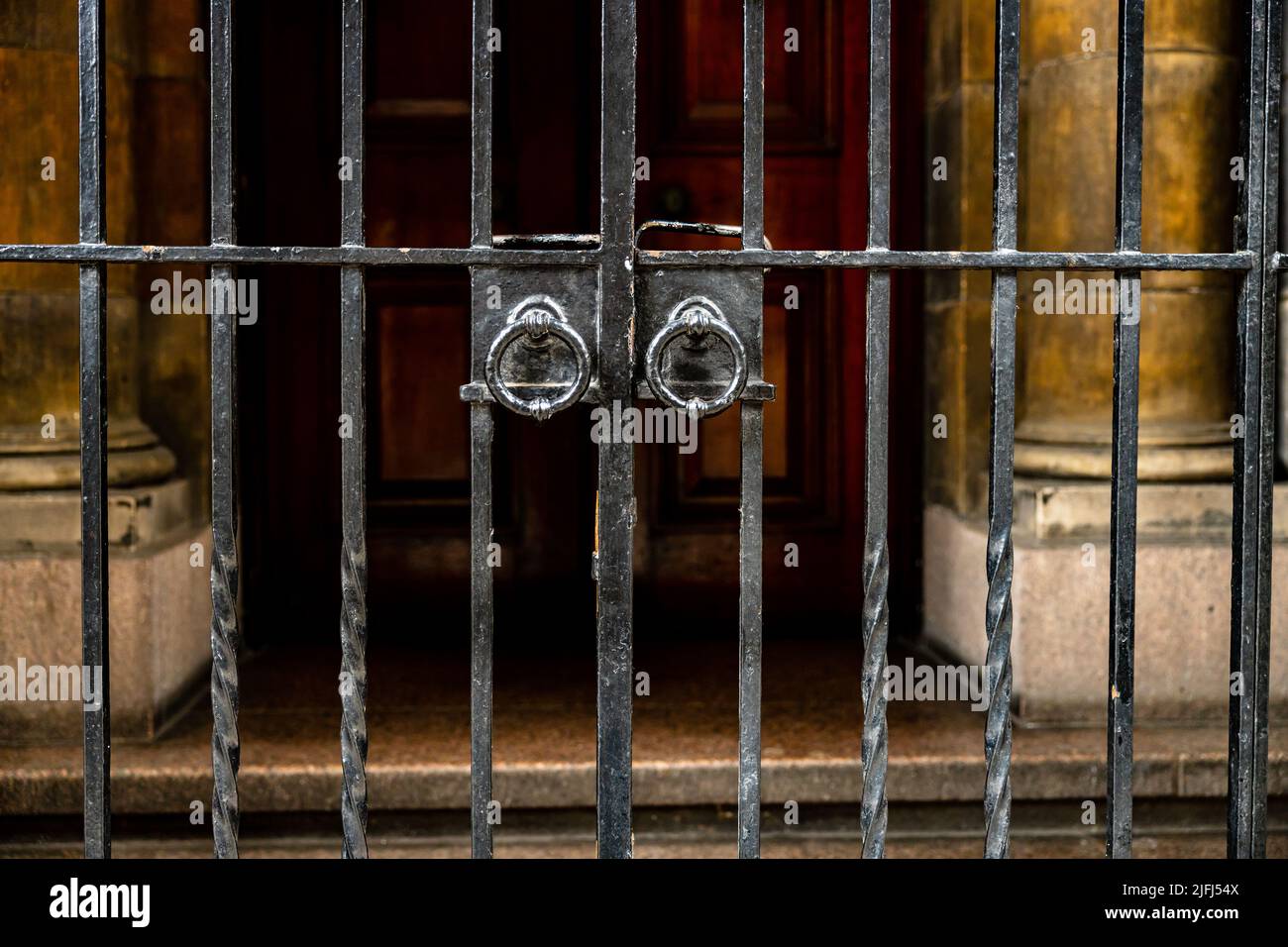 Landscape format of closed black wrought iron railings forming gates ...
