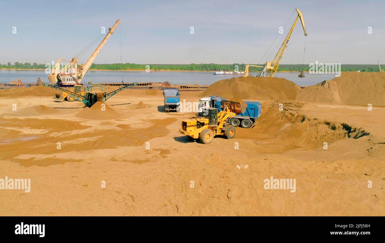 Excavator , trucks and cranes working at the construction site. Scene ...