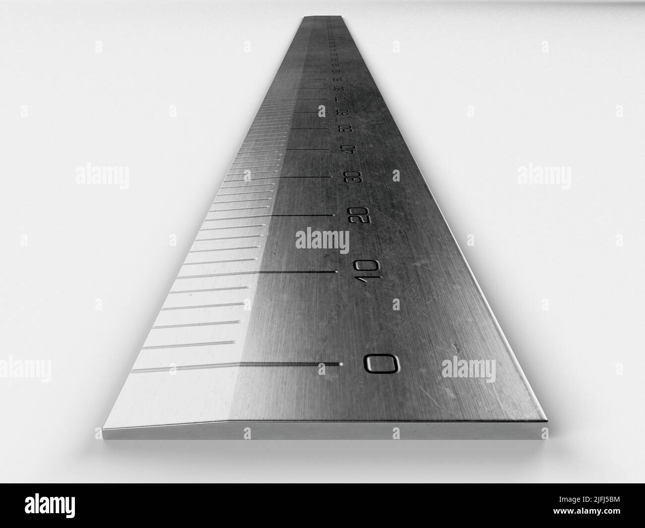 A close up view of a section of a steel ruler with indented ...