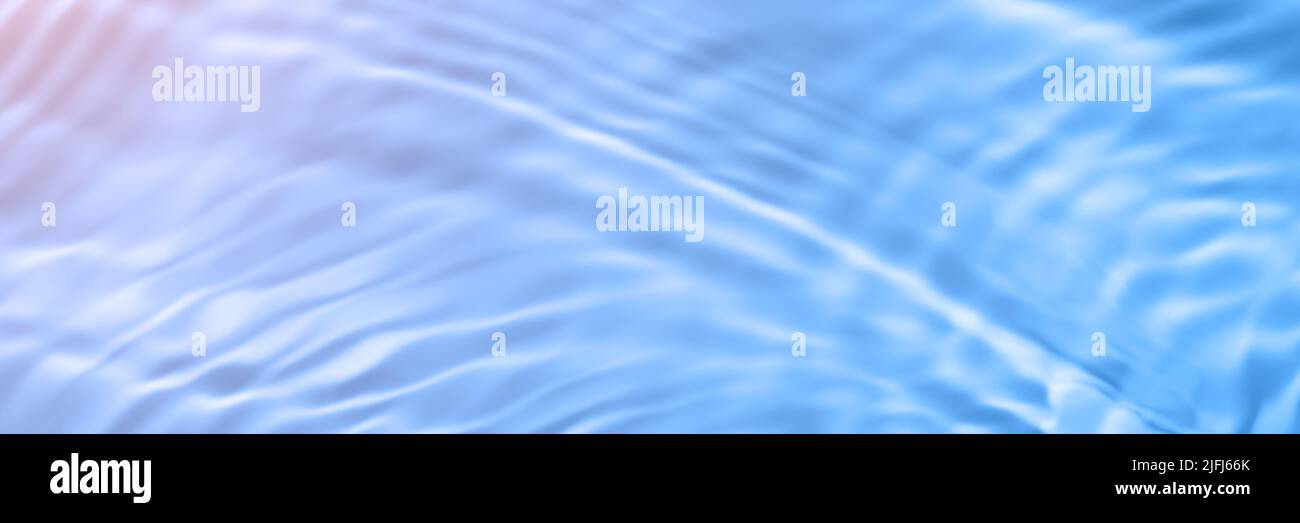 Serum or water texture close up. Light blue and pink gradient liquid ...