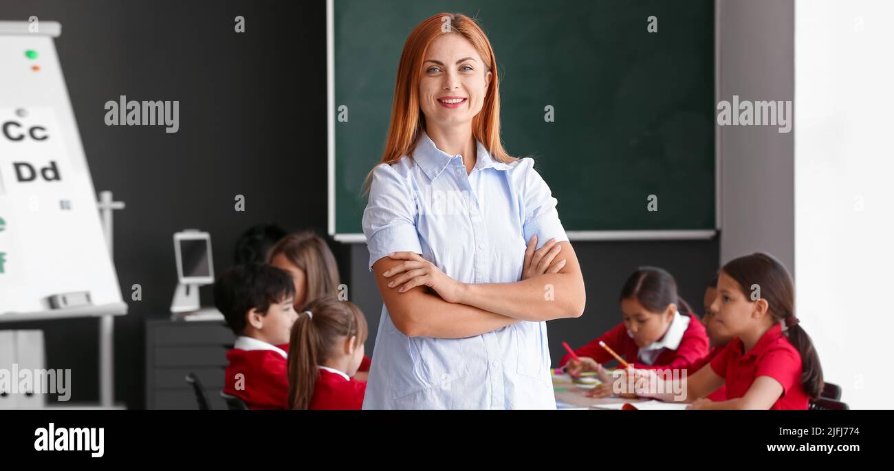 Portrait of beautiful teacher in classroom Stock Photo - Alamy