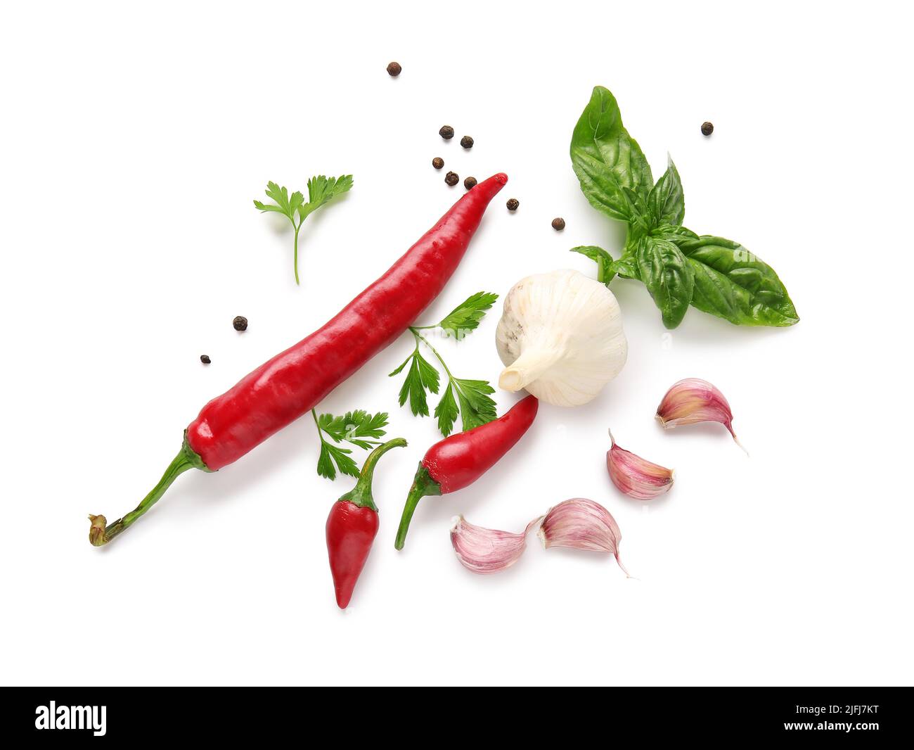 Composition with fresh chili peppers, garlic and herbs on white ...
