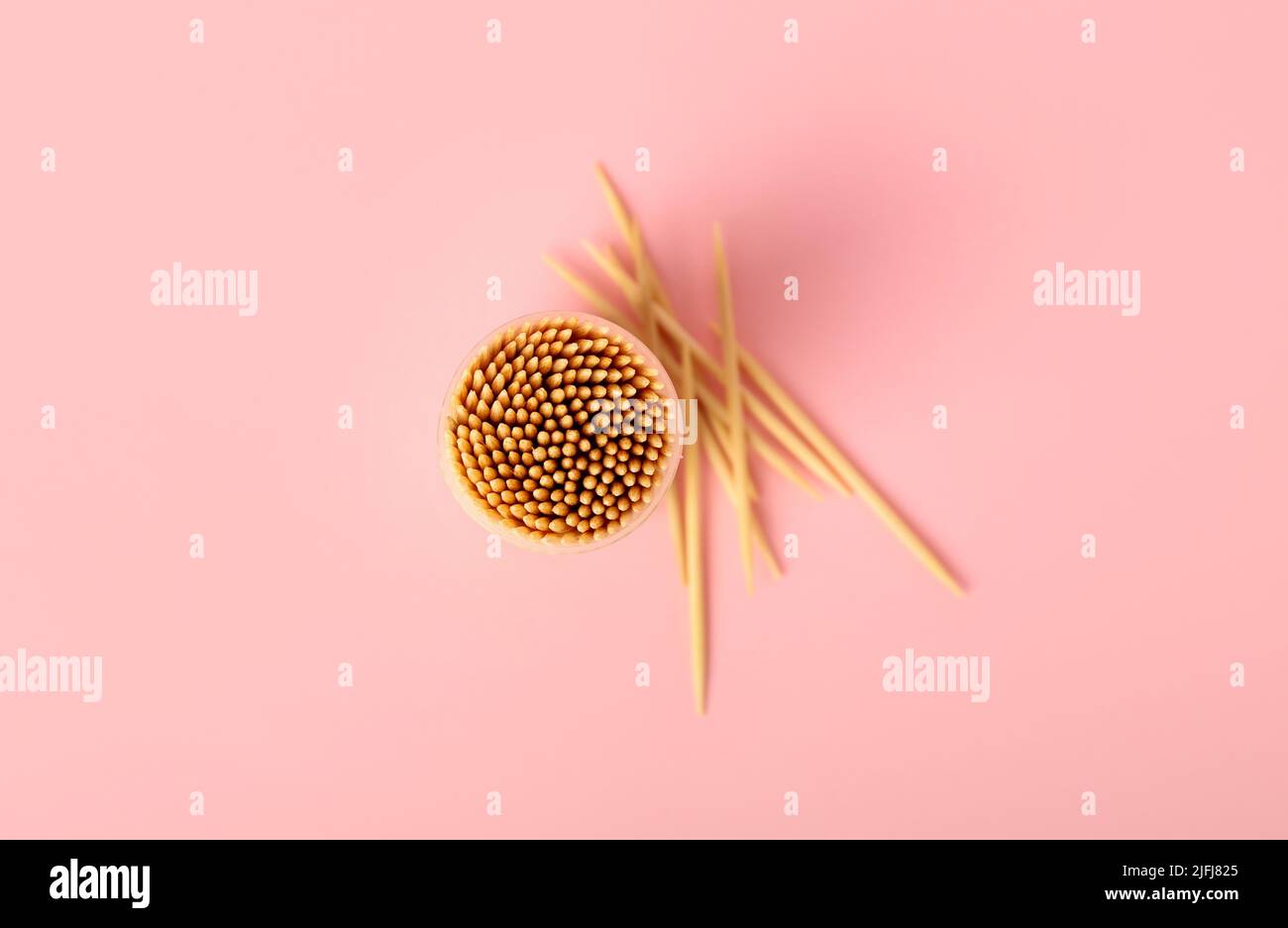 Box with wooden toothpicks on pink background Stock Photo - Alamy