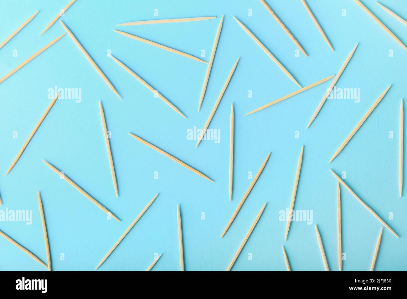 Many toothpicks on blue background Stock Photo - Alamy
