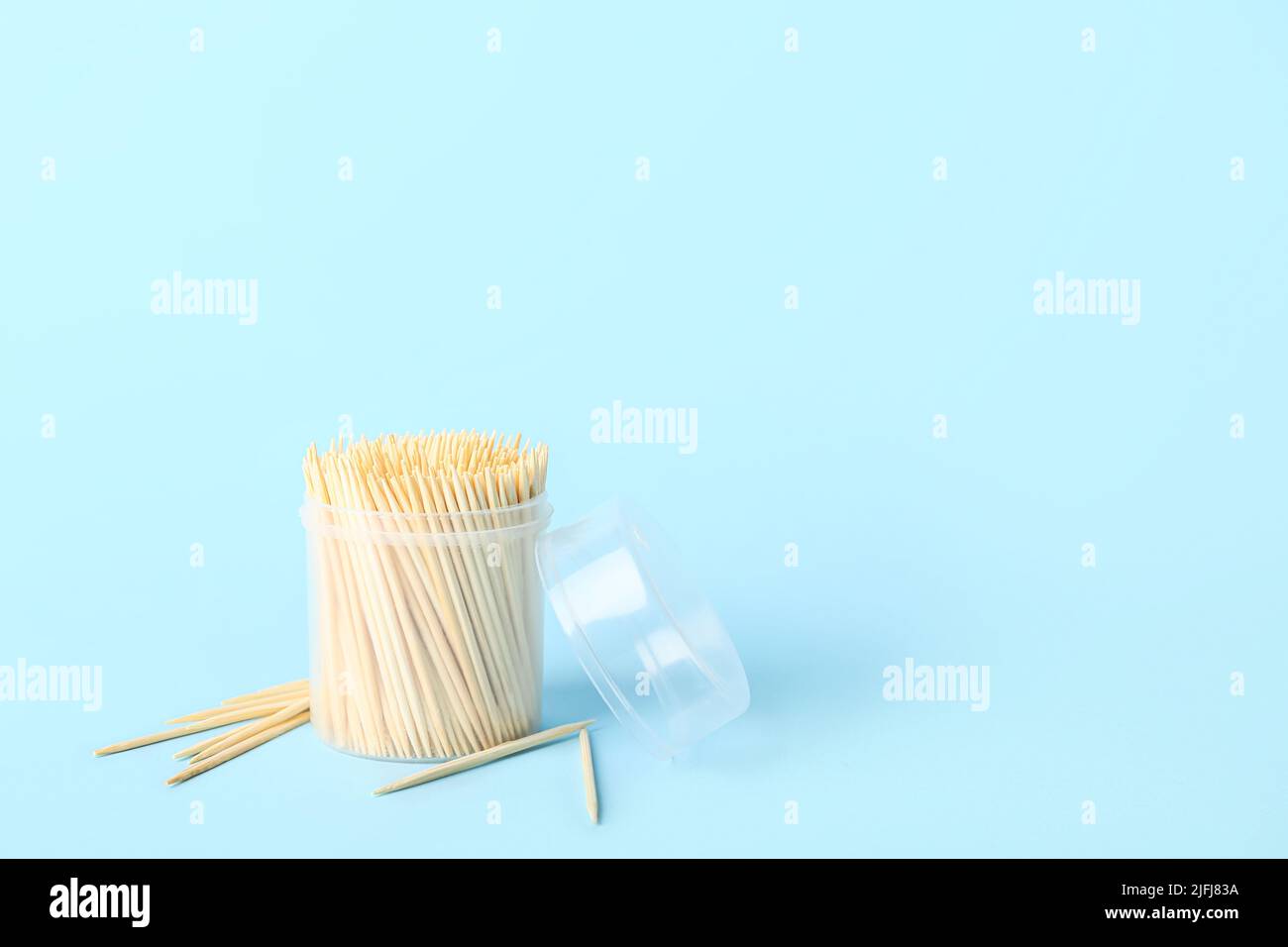 Plastic holder with toothpicks on blue background Stock Photo - Alamy
