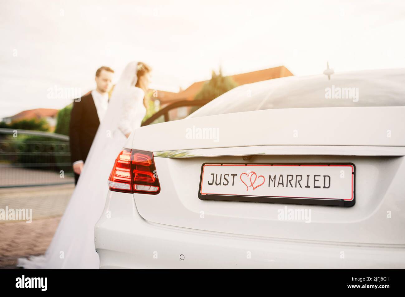 Top view, a newlywed couple is driving a retro car, the bride is ...