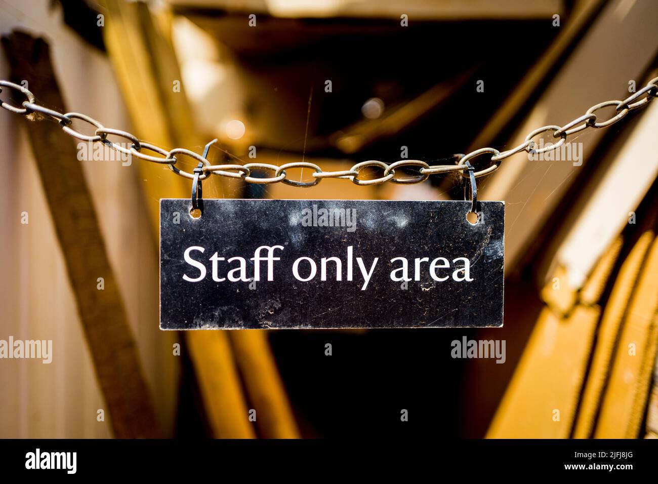 Staff only area sign attached to a metal chain Stock Photo - Alamy