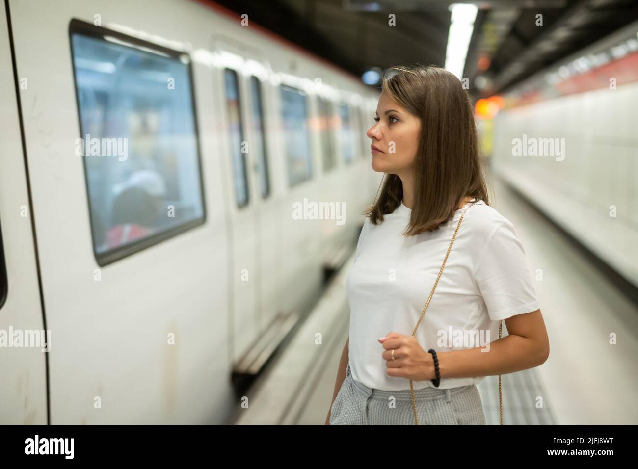 Female on platform of metro station Stock Photo - Alamy