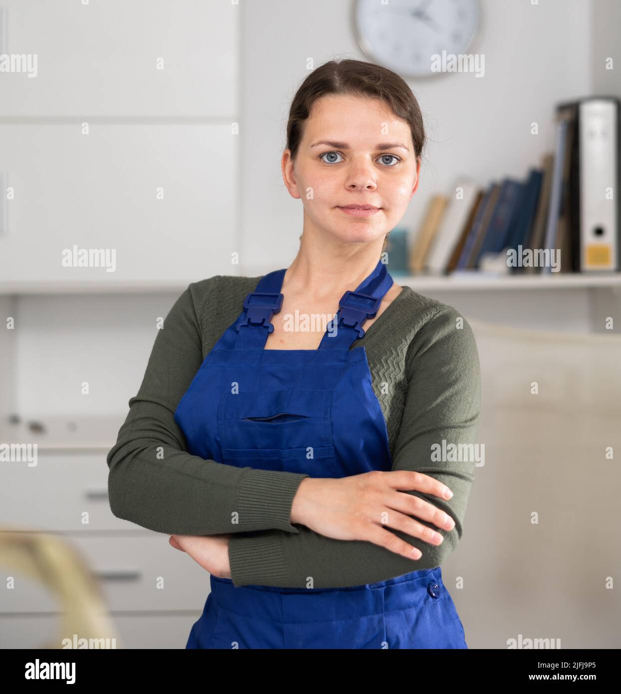 Female cleaning service worker standing in office Stock Photo - Alamy
