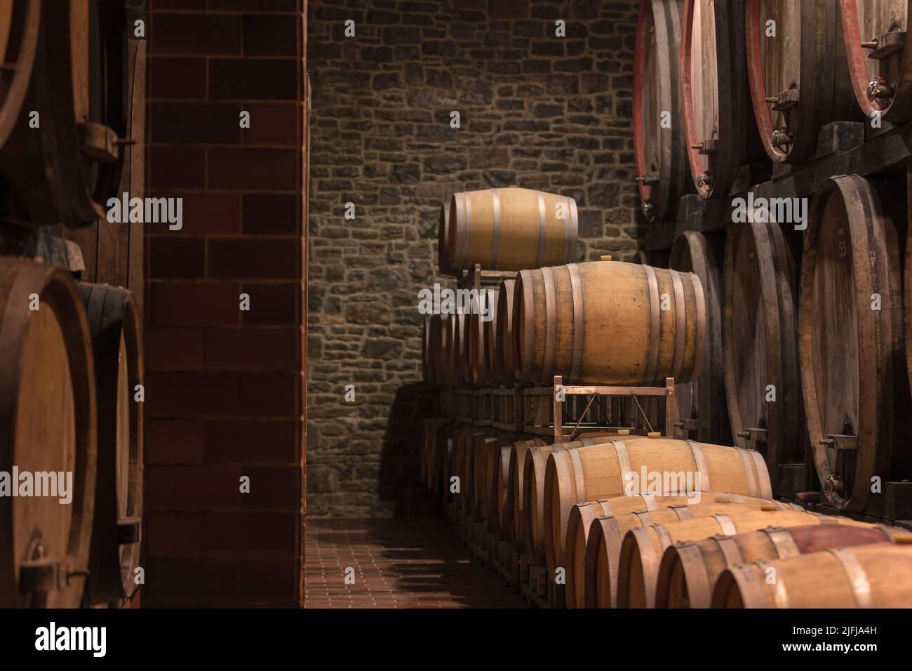 The ambiance of the traditional wine cellar, aging red wine barrels ...