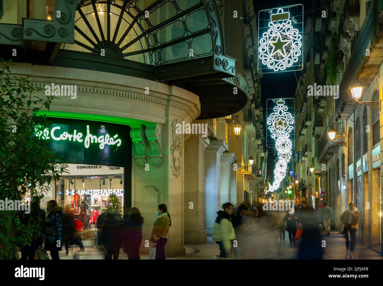 Night view of illuminated busy Barcelona street with Christmas ...