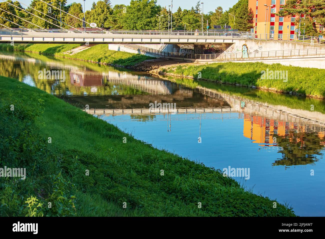 The river flows through the city. On the calm surface of the river ...